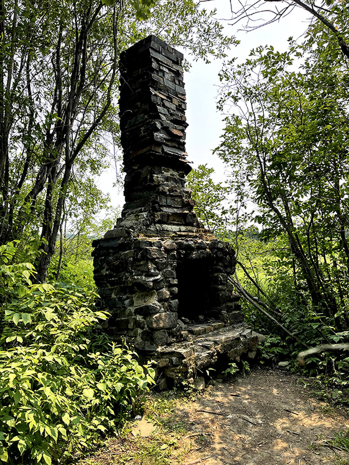 This stone chimney stands as a silent sentinel to history, whispering tales of the voyageurs who once traversed these lands.