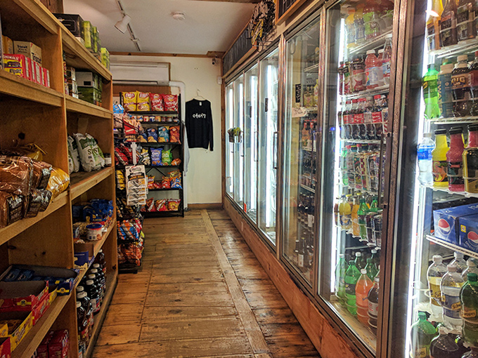 The beverage aisle stretches toward the back of the store, a liquid library of options from practical hydration to celebratory libations.