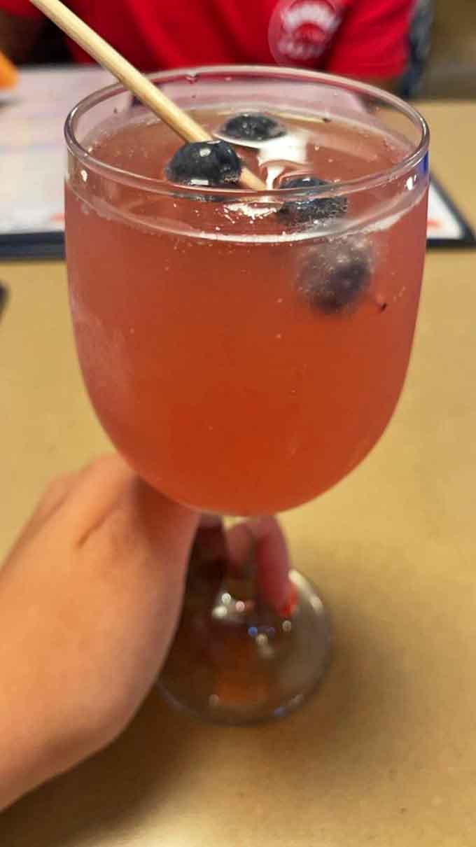 A blueberry-infused mimosa with floating berries transforms ordinary brunch into something Instagram-worthy and delightfully refreshing.