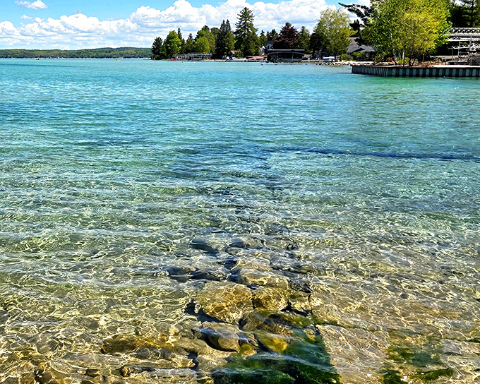When Mother Nature decides to show off, you get Torch Lake's sandbar, where sugar-sand meets electric blue in perfect harmony.