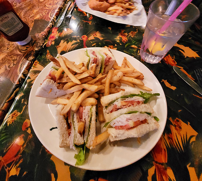 This club sandwich stacks turkey, bacon, and fresh veggies between toasted bread &ndash; a familiar favorite amid the exotic surroundings.