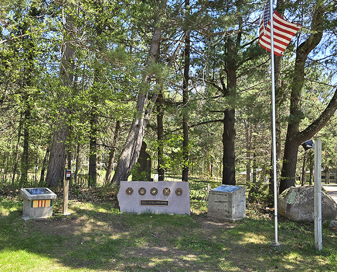 A solemn tribute to veterans stands beneath the American flag, demonstrating how even concrete can convey profound respect and gratitude.