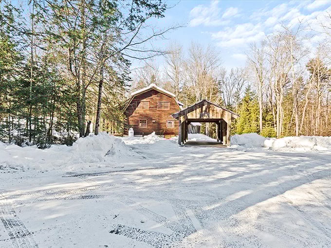 Winter's transformation: snow blankets the landscape, turning summer's swimming hole into a serene portrait of New England's seasonal magic.
