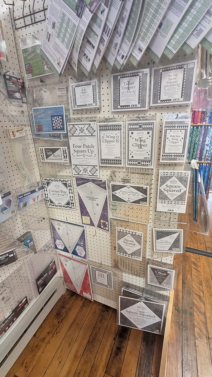 Quilting rulers, templates, and tools line the walls like the secret weapons they are &ndash; precision instruments for turning fabric chaos into ordered beauty.