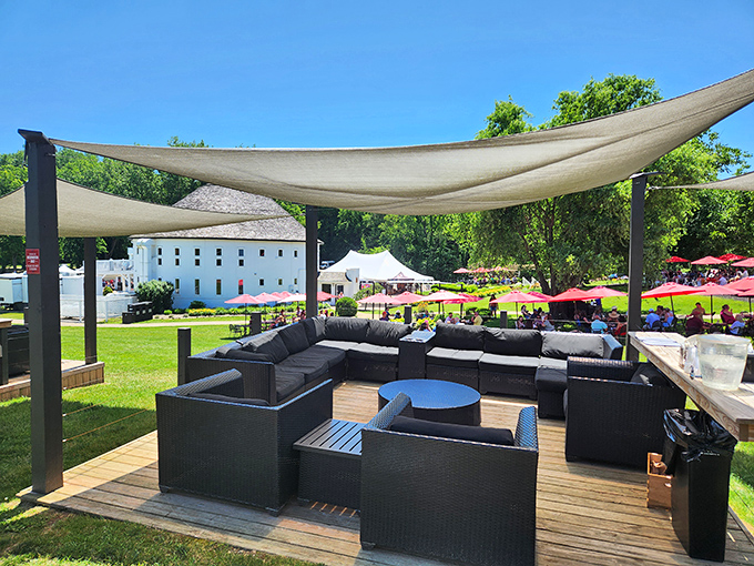 Shaded sanctuary: Plush outdoor seating beneath canvas sails creates the perfect retreat for sipping and socializing while overlooking the picturesque grounds.
