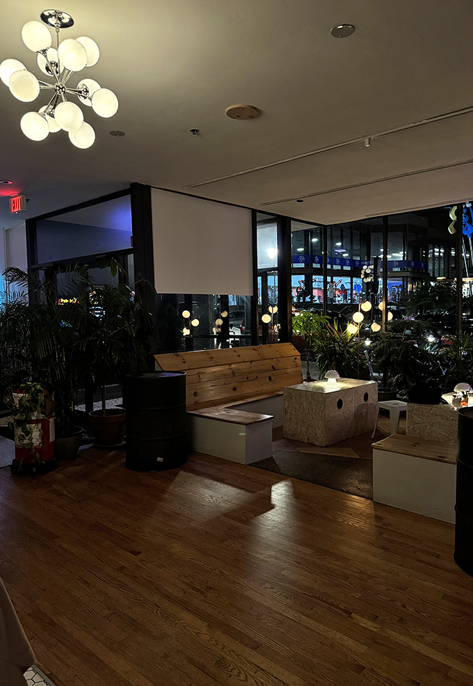 Mid-century modern meets gaming lounge in this stylish seating area, where plants and pendant lights create an oasis for between-game breathers.