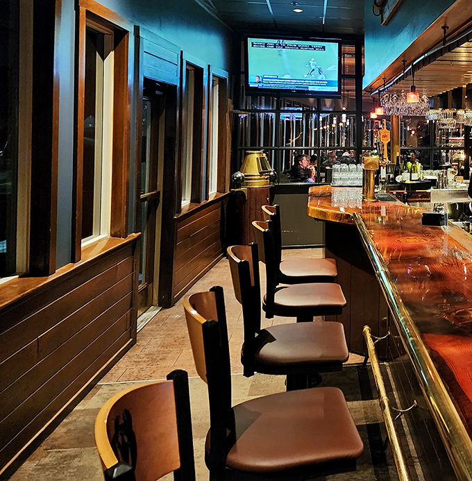 The polished bar invites patrons to settle in for stories and spirits &ndash; nautical charm meets mixology magic.