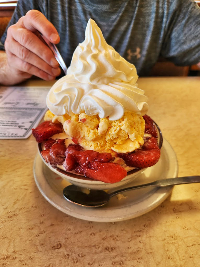 A mountain of whipped cream crowns this strawberry shortcake &ndash; dessert that doesn't whisper sweet nothings but shouts them gloriously.