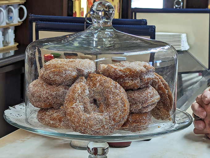 The famous Blue Benn donuts, displayed under glass like the treasures they are, dusted with cinnamon sugar that clings to your fingers.