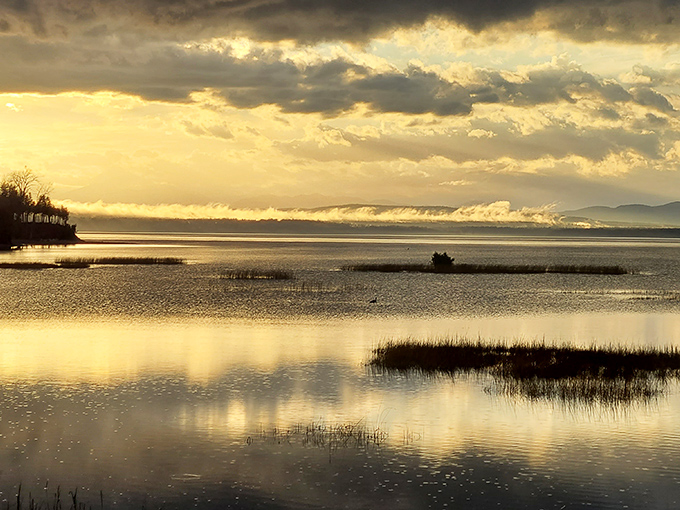 That magical moment when day surrenders to dusk, painting Lake Champlain in watercolor hues no artist could fully capture.