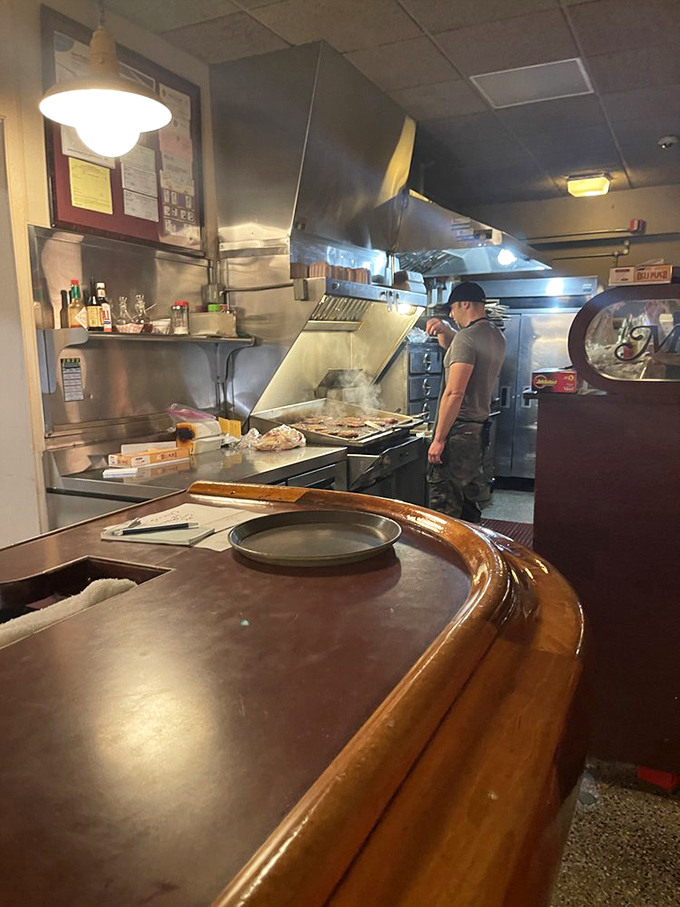 A glimpse into the kitchen where burger magic happens on a flat-top grill that's been seasoning itself for decades.