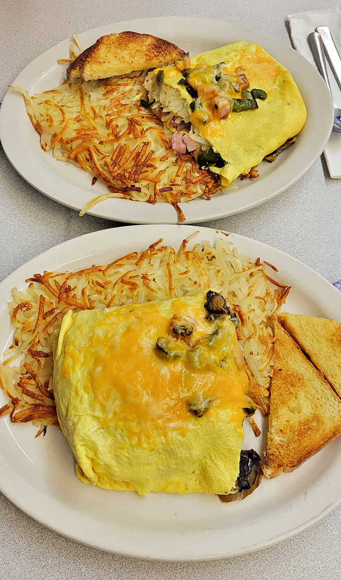 Two breakfast champions &ndash; fluffy omelets stuffed with savory fillings beside hash browns with the perfect crisp-to-tender ratio.