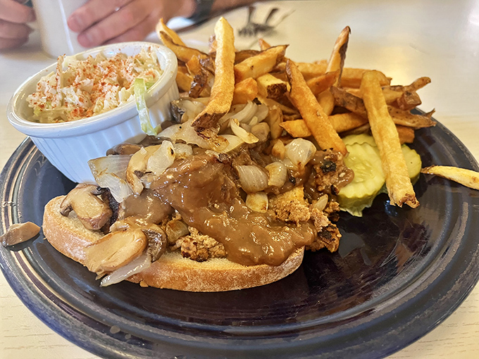 The open-faced roast beef sandwich swimming in gravy is comfort food at its finest, proving that some dishes are improved by drowning them in deliciousness.