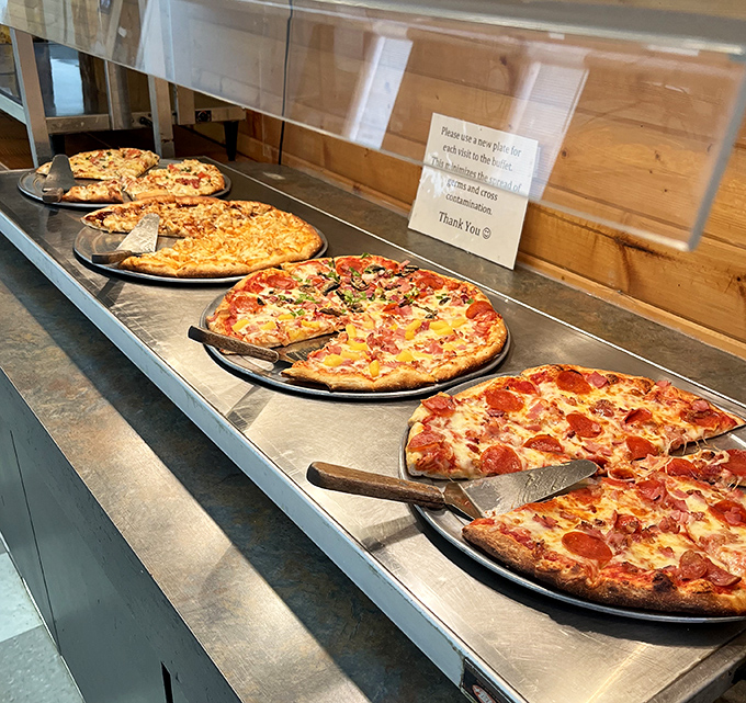 Fresh from the oven, the buffet display offers a rotating selection of piping hot pizzas ready for the taking.