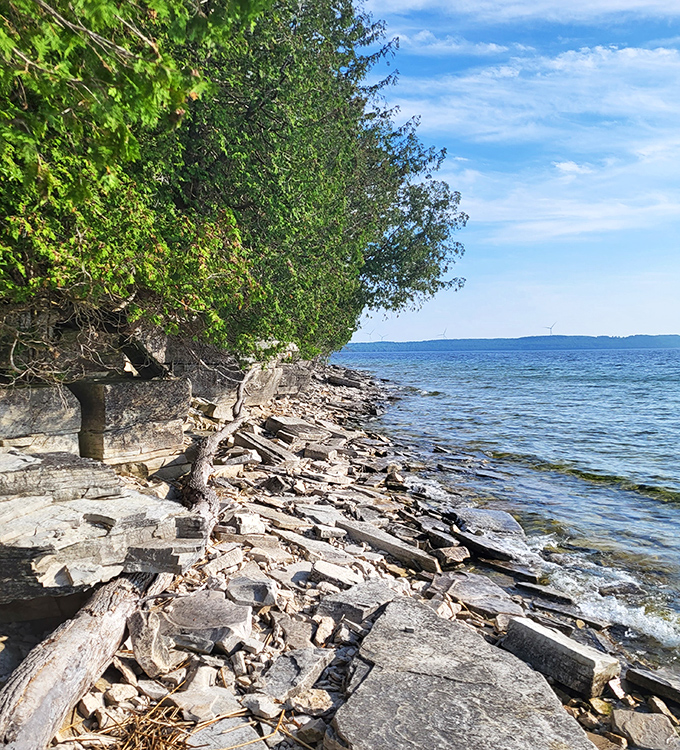 Lake Michigan laps against the rocky shoreline, the same waters that once carried ships laden with iron ore and finished products.