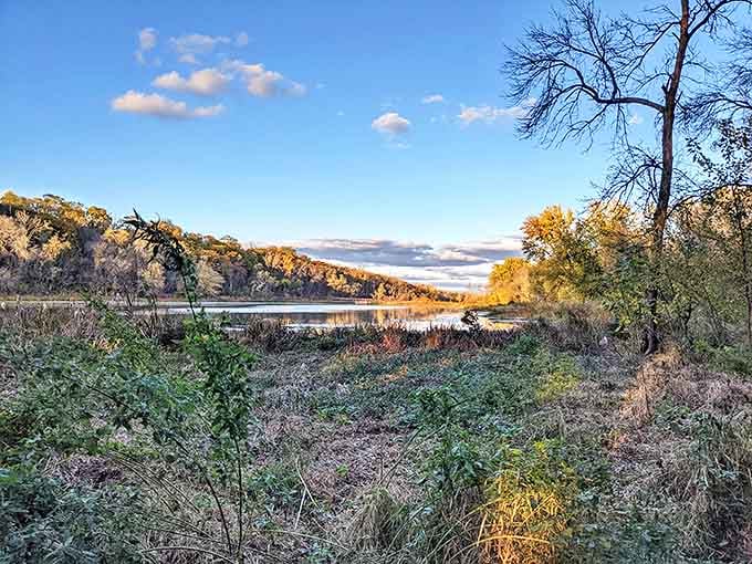 Golden hour magic at Crosby Farm, where the setting sun paints the water and surrounding autumn foliage in warm, glowing hues.