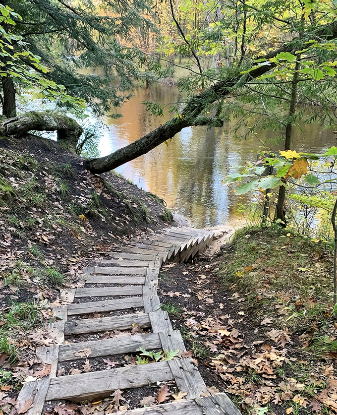 These wooden steps don't just lead to the river, they're a stairway to tranquility, each weathered plank a reminder of countless footsteps before yours.