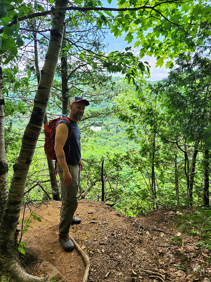 A hiker pauses to soak in the magnificent view &ndash; that moment when you realize your office cubicle feels very far away.
