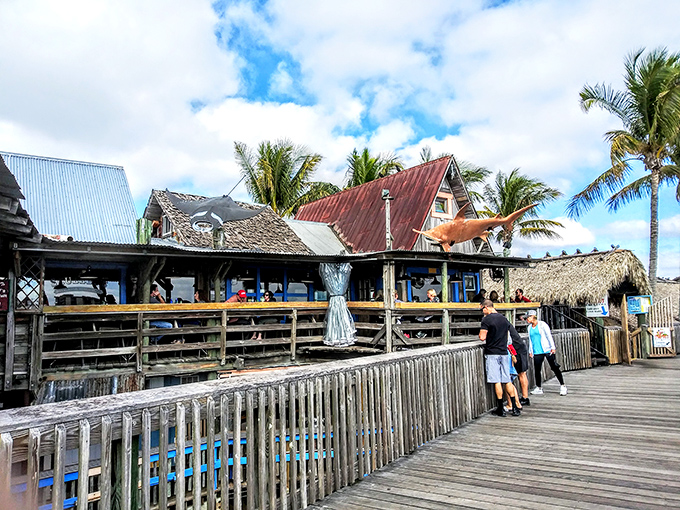 Visitors explore the boardwalk's charms, discovering that the real Florida isn't found in brochures but in these sun-drenched wooden walkways.