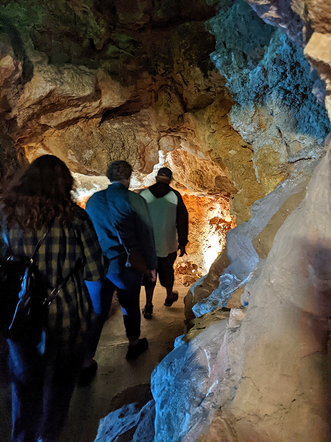 Tour groups follow guides through narrow passages, where every turn reveals another geological masterpiece millions of years in the making.