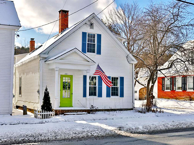 That lime green door isn't just a pop of color, it's a cheerful hello against the crisp white clapboard of a classic Vermont cottage.