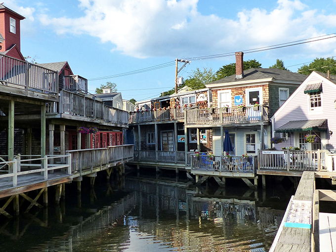 Dock Square's wooden walkways hover above the water like a maritime village from a storybook. Each weathered board tells tales of countless summer visitors.