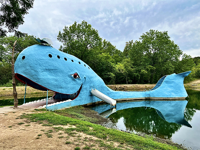 Oklahoma's famous Blue Whale smiles at visitors from his pond, a whimsical roadside attraction that's impossible to pass by.