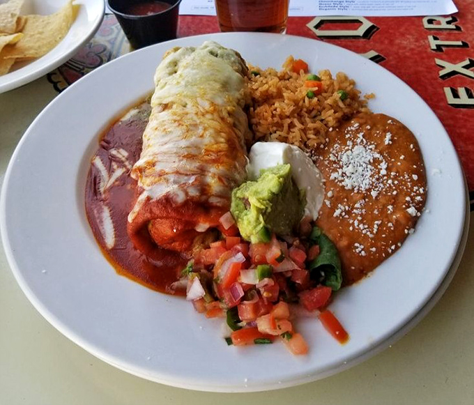 El Charro's legendary chimichanga comes smothered in sauce and accompanied by traditional rice and beans &ndash; Mexican comfort food at its finest.