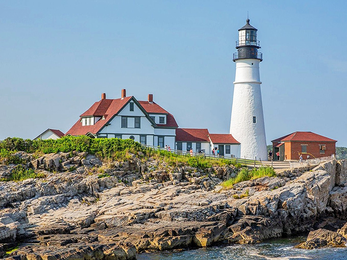 Kennebunk's famous lighthouse perches dramatically on jagged rocks, where crashing waves have tested its strength for generations.