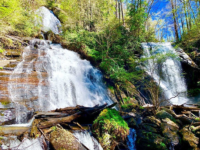 The mysterious subterranean waterfall drops dramatically through ancient limestone, illuminated to showcase its otherworldly beauty.