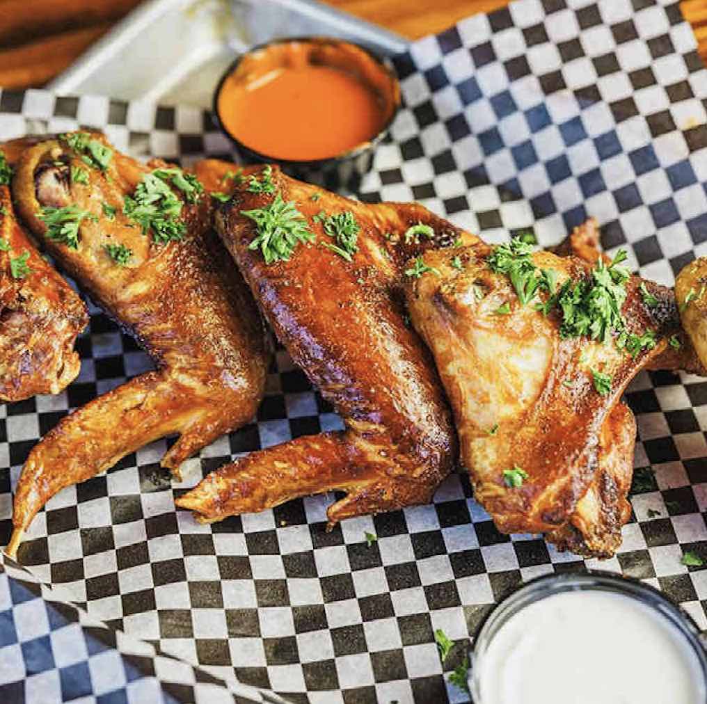 Barbecue chicken that defies the usual dry fate of smoked poultry, remaining juicy and tender beneath skin that crackles with flavor.