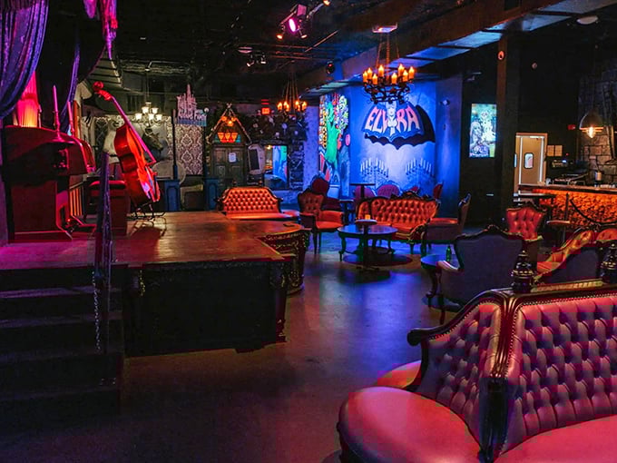 The main lounge area at Cocktails & Screams bathes visitors in moody lighting and Victorian-inspired decor, creating an atmosphere where Halloween never ends.