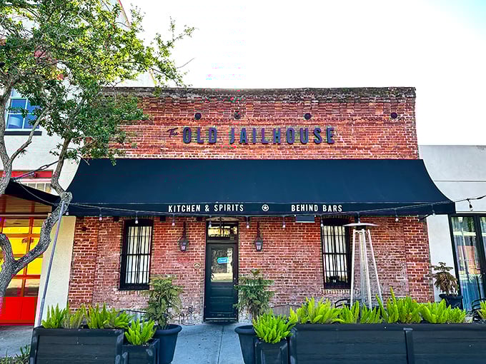 The weathered brick facade of The Old Jailhouse stands as a testament to history, now serving sentences of culinary delight rather than hard time.