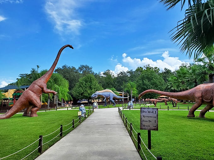 Welcome to prehistoric Florida, where towering dinosaurs greet visitors along manicured paths under brilliant blue skies.