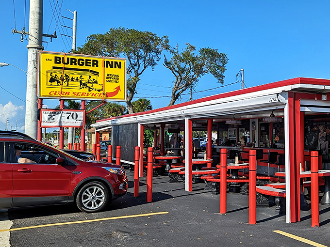 The iconic yellow sign promises "CURB SERVICE SINCE 1952" &ndash; a bright beacon of burger bliss that's been guiding hungry travelers for generations.