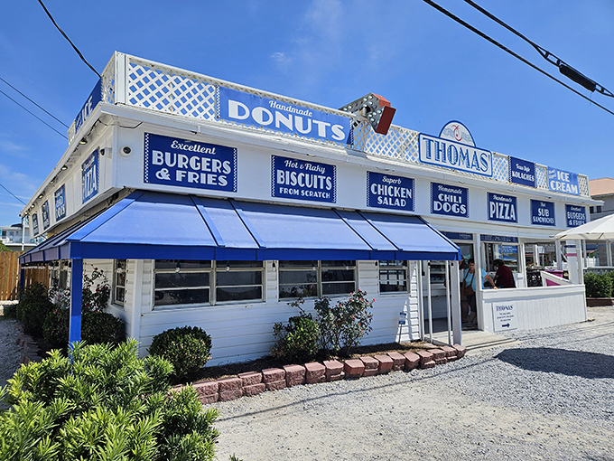 The iconic blue and white exterior of Thomas Donut beckons like a sugary lighthouse on Panama City Beach's shoreline.