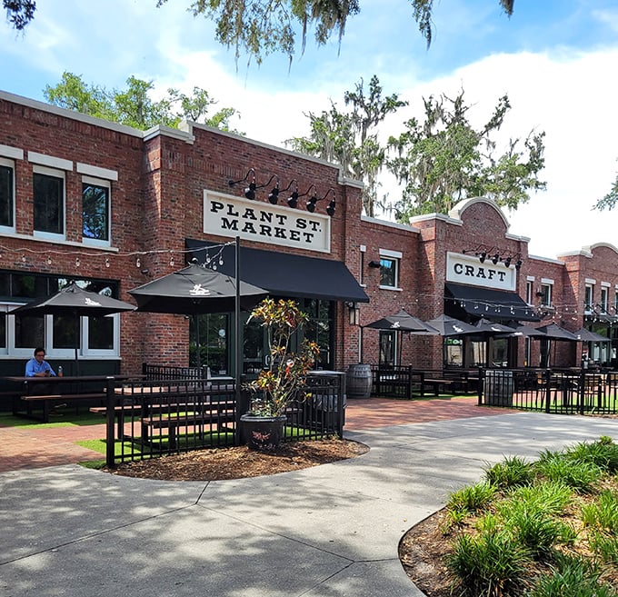 The welcoming brick facade of Plant Street Market stands proudly under Florida's blue skies, promising culinary adventures within its walls.