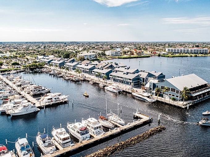 Aerial view of Fishermen's Village marina – where boats bob like bathtub toys and shopping bags swing in rhythm with the Gulf breeze.