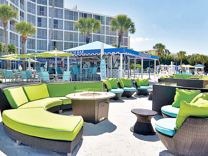 Vibrant turquoise seating creates a beachfront oasis at RumFish Beach Resort, where every chair promises front-row tickets to nature's greatest show.