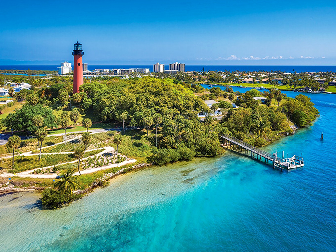 A crimson sentinel rising from lush tropical foliage, the Jupiter Lighthouse has guided mariners safely home since 1860.