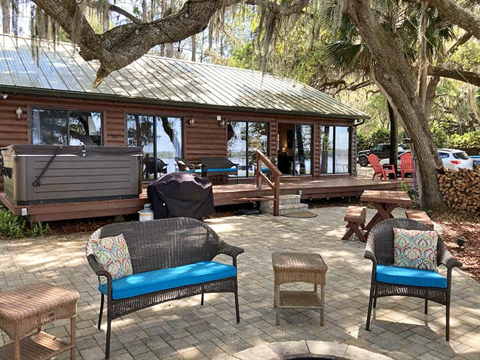 Rustic luxury meets lakeside serenity at this log cabin retreat, where Spanish moss-draped oaks stand guard over your escape from reality.