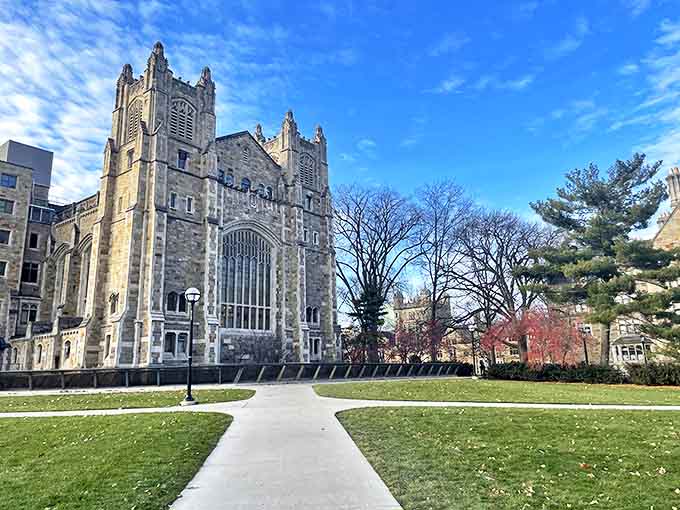 The imposing gothic facade of Michigan Law's main building reaches skyward, as if trying to touch the clouds that drift across Ann Arbor's blue canvas.