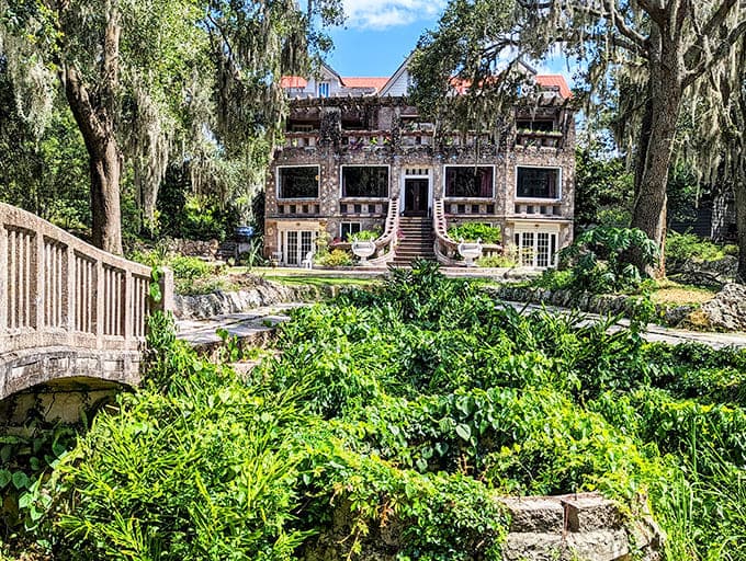 The Wonder House rises from its lush surroundings like something from a storybook, proving that Spanish moss and shell-covered concrete make surprisingly good neighbors.
