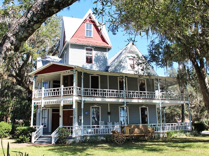 Victorian elegance with a spectral twist: The May-Stringer House stands proudly on its Brooksville hilltop, red roof peaks hinting at secrets within.