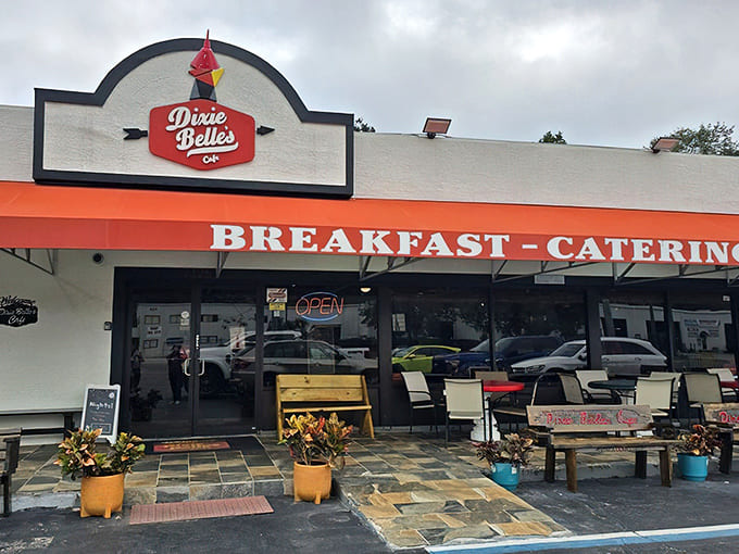 That cheerful red sign and welcoming exterior practically shout "come in for the best biscuits of your life!"