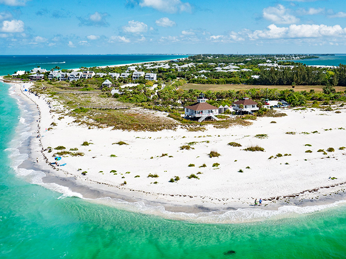 Aerial view of Boca Grande's pristine coastline, where turquoise waters meet powdery white sand in a postcard-perfect Florida embrace.