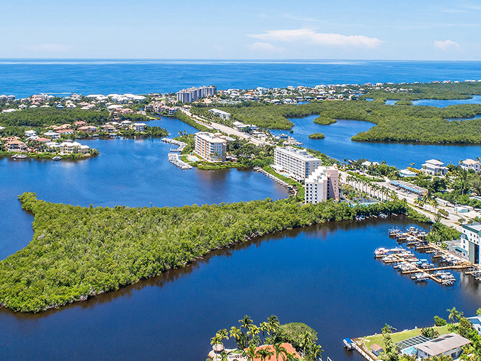 Aerial view of Bonita Springs where mangroves embrace waterways like old friends reuniting after a long absence.