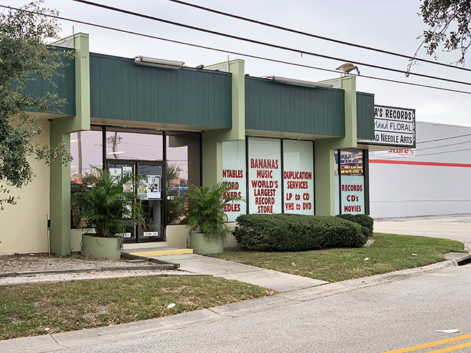 The unassuming green exterior of Bananas Records belies the musical wonderland waiting inside, with bold red signage promising vinyl treasures beyond the door.