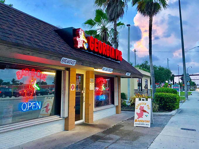 The iconic Georgia Pig exterior beckons with its vintage charm and glowing neon signs &ndash; a barbecue lighthouse guiding hungry travelers home.