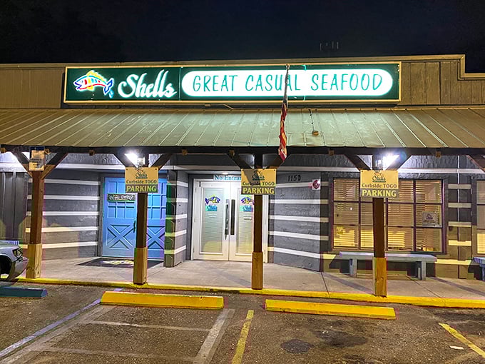 The welcoming glow of Shells Seafood's neon sign promises "GREAT CASUAL SEAFOOD" &ndash; a beacon for hungry seafood lovers in the Florida night.